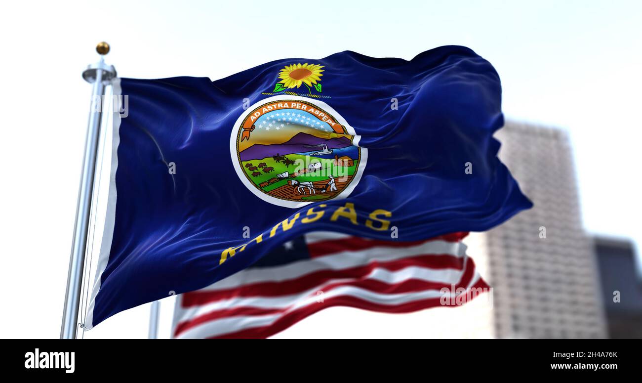 the flag of the US state of Kansas waving in the wind with the American ...
