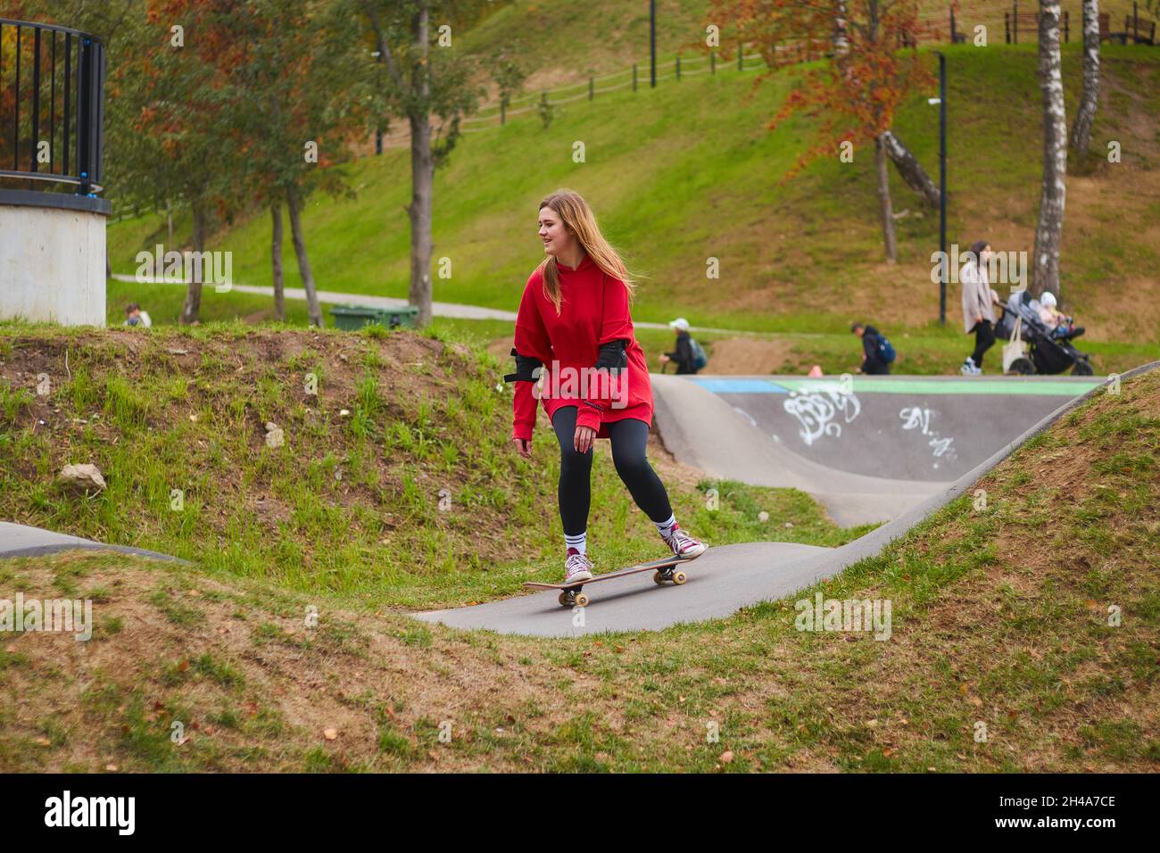 young girl rides in a skate park in clear weather. park for Stock Photo ...