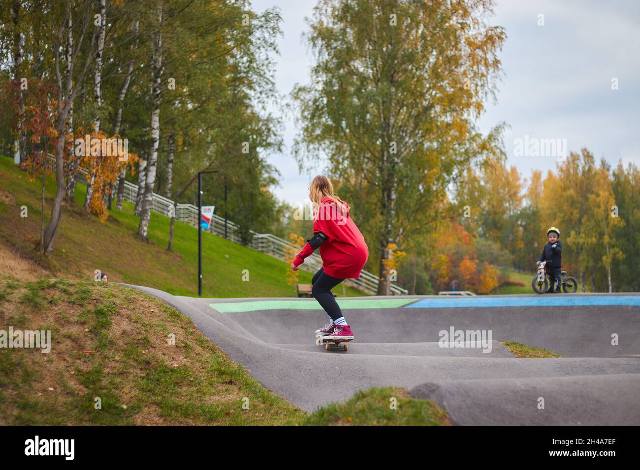 young girl rides in a skate park in clear weather. park for Stock Photo ...