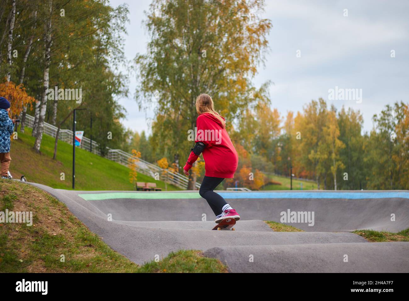 young girl rides in a skate park in clear weather. park for Stock Photo ...