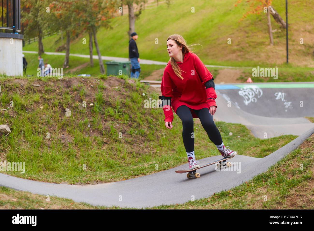 young girl rides in a skate park in clear weather. park for Stock Photo ...