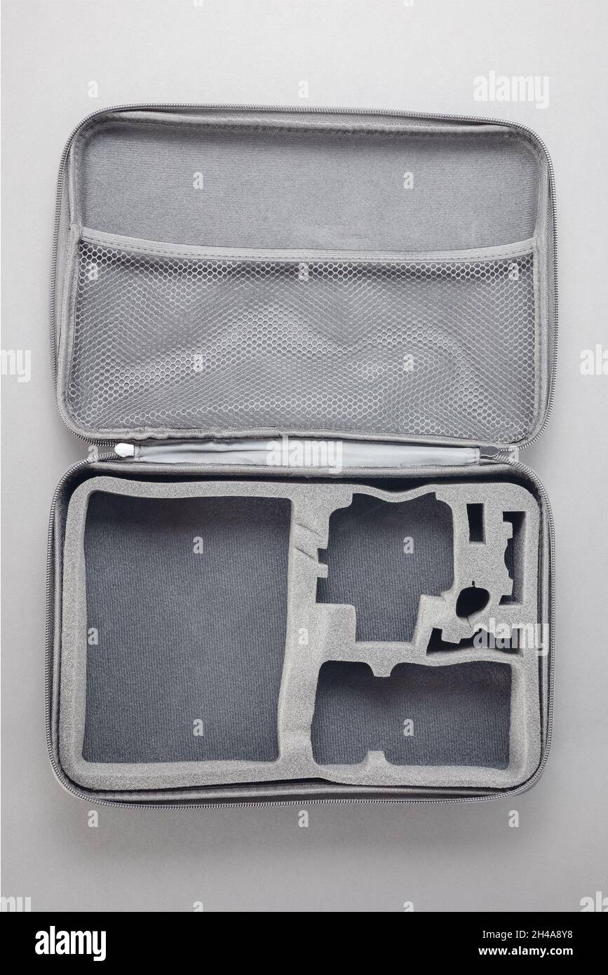 Open soft gray suitcase in which there are several sections for ...