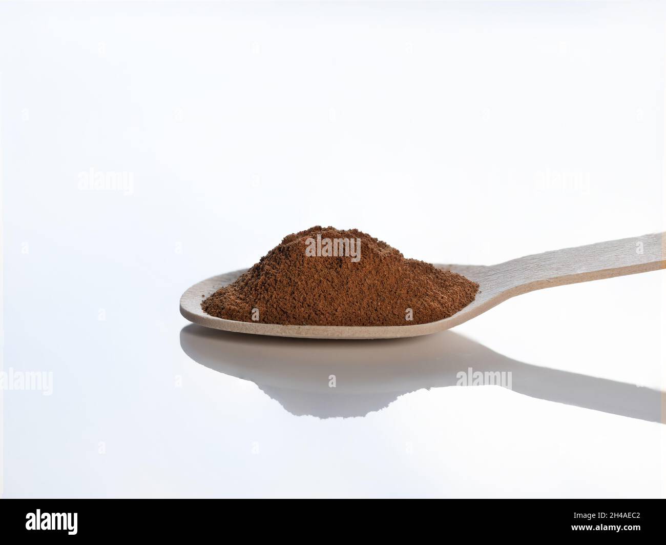 Wooden spoon with powdered cinnamon on a white background Stock Photo ...