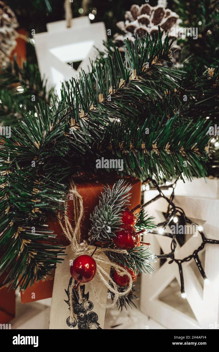 Festive gift boxes on the Christmas tree, New Year decorations, paper ...