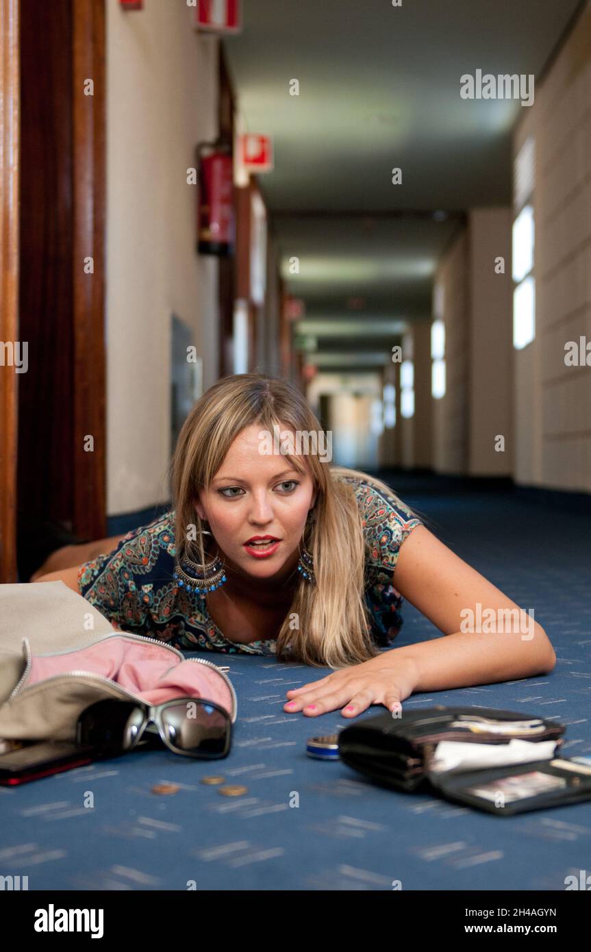 woman who stumbles and falls to the ground with her things Stock Photo ...