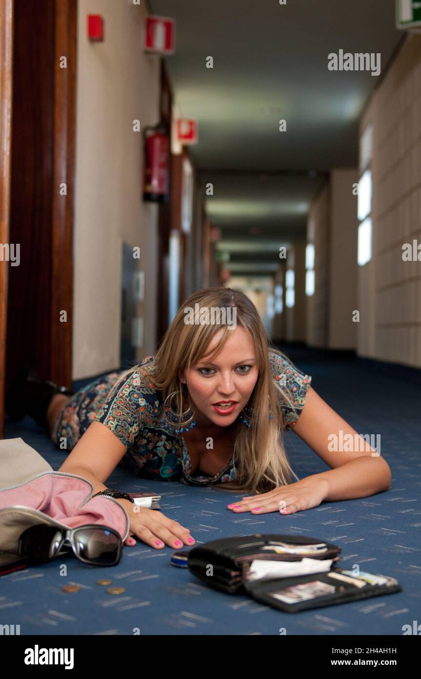 woman who stumbles and falls to the ground with her things Stock Photo ...