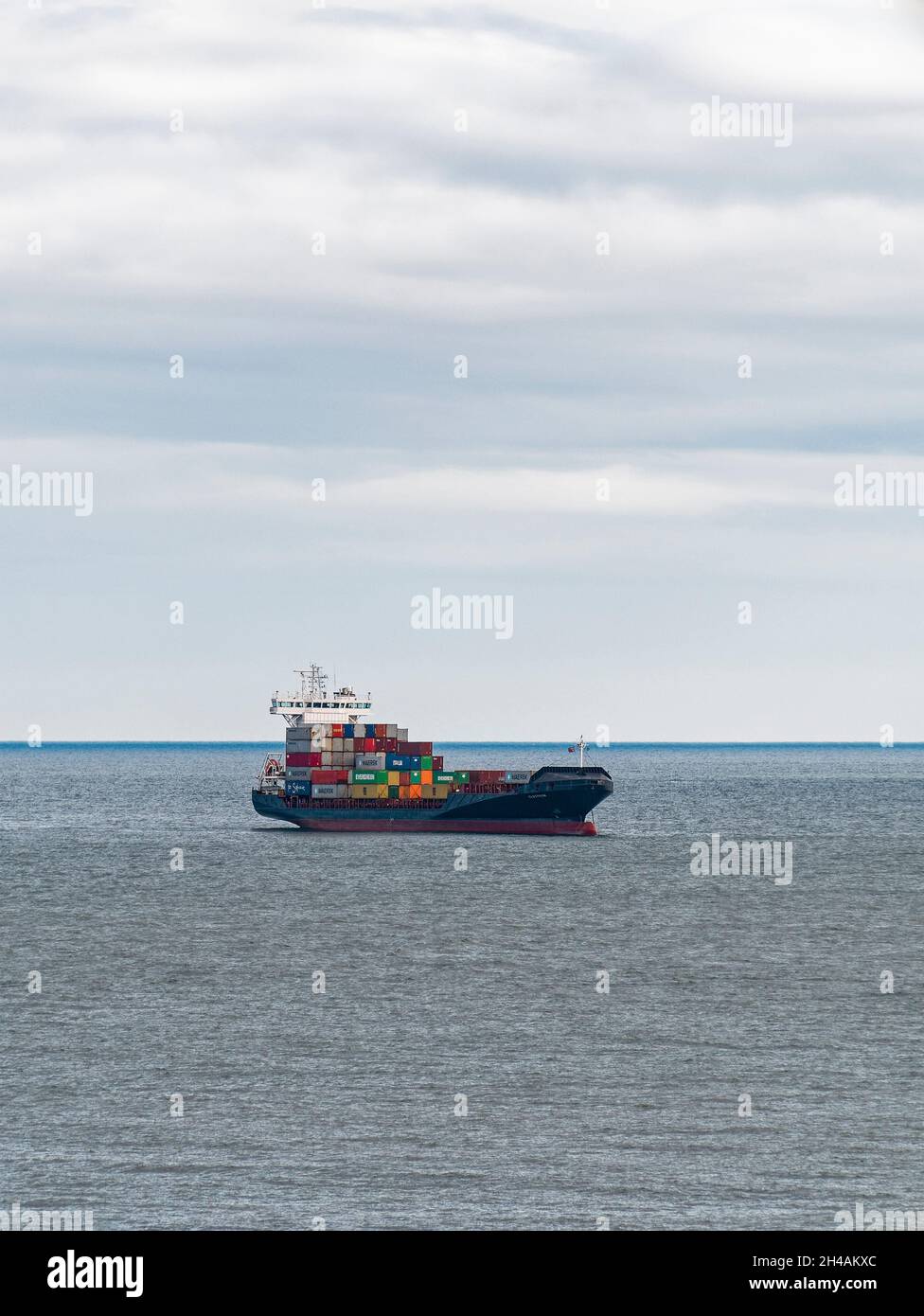 A container ship in the North Sea off Tynemouth waiting for the tide to ...