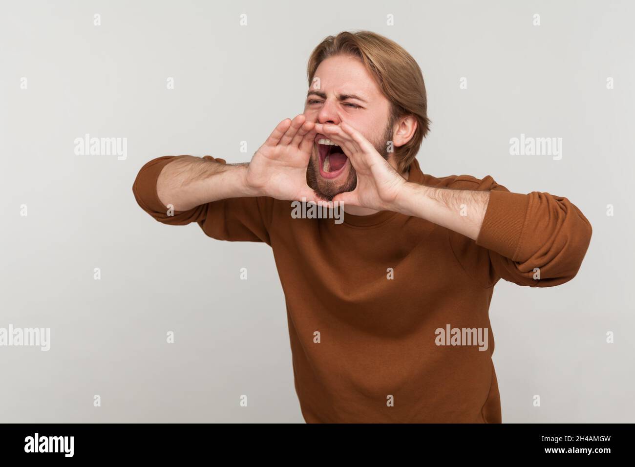 Portrait of furious attractive man with beard wearing sweatshirt ...