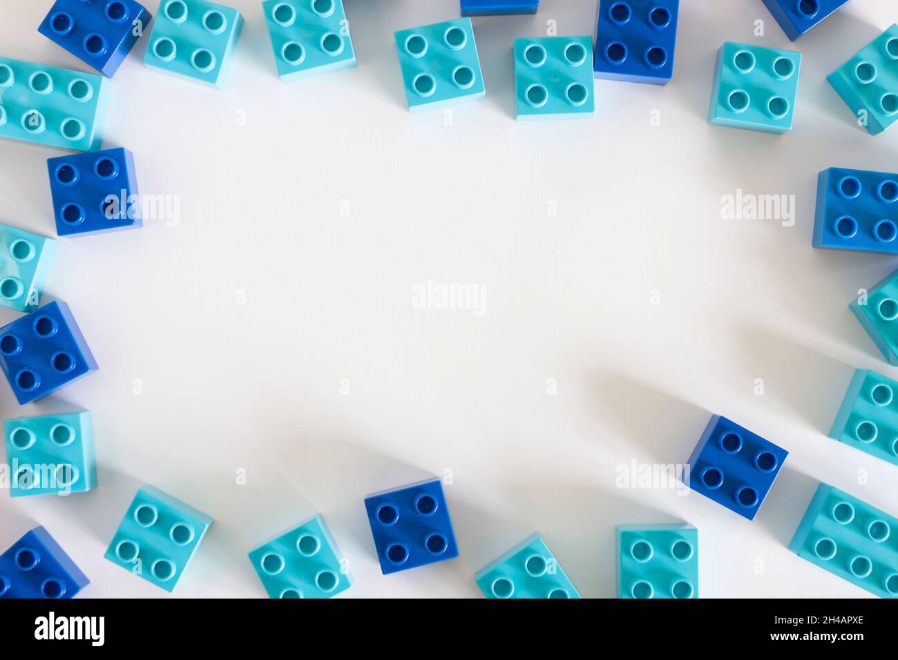 Blue plastic building blocks with empty copyspace on white background ...