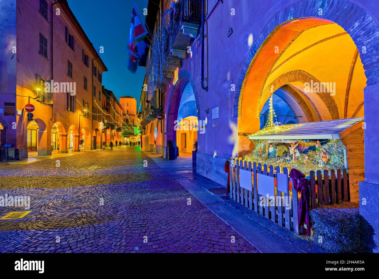 Christmas native scene on cobblestone street illuminated by holiday ...