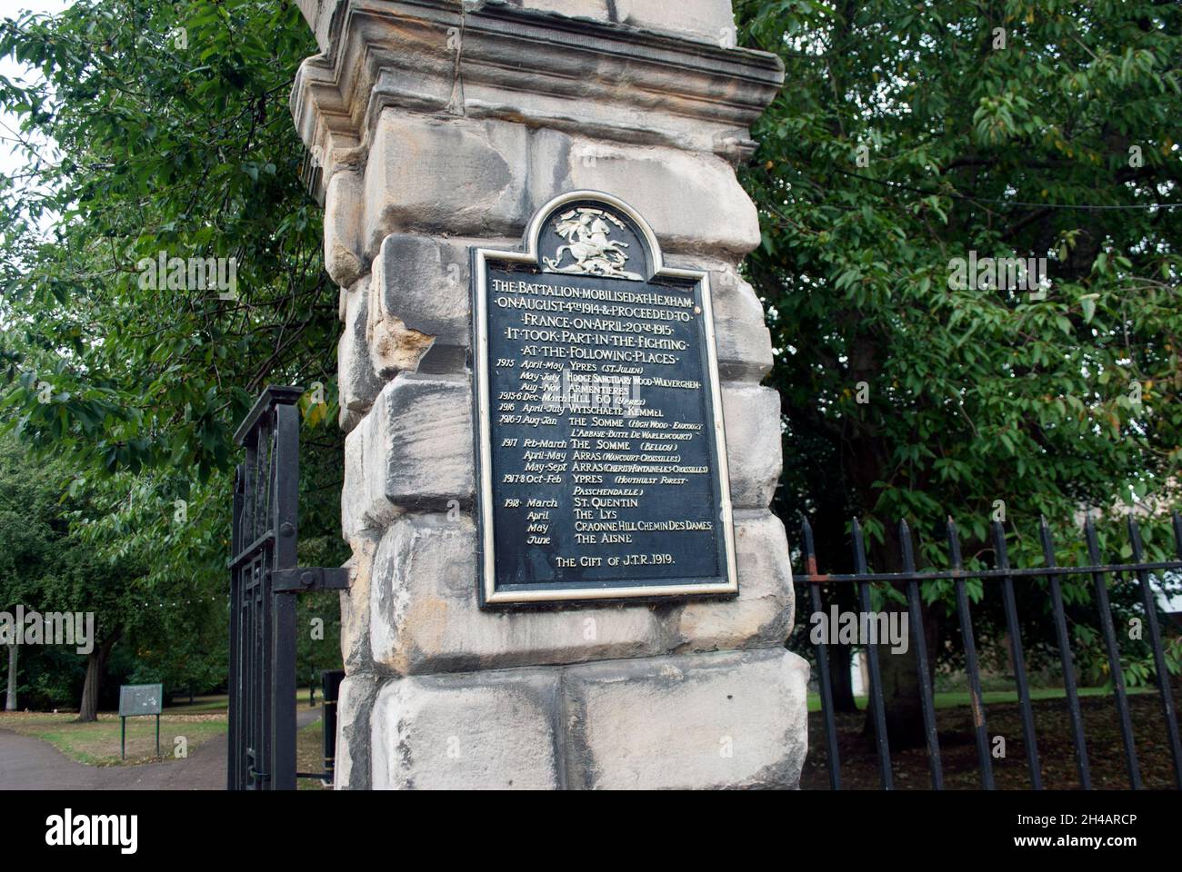 Bronze metal sign on stone commemorative arch entrance to Hexham Park ...