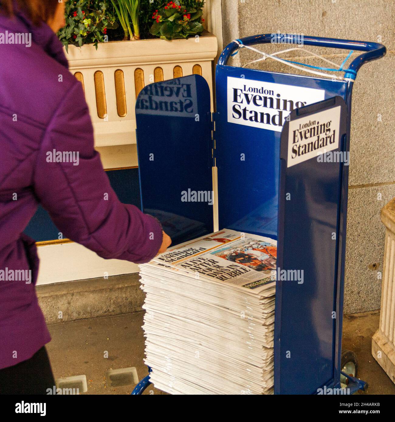 London, United Kingdom; March 15th 2011: Woman picking up a copy of the ...