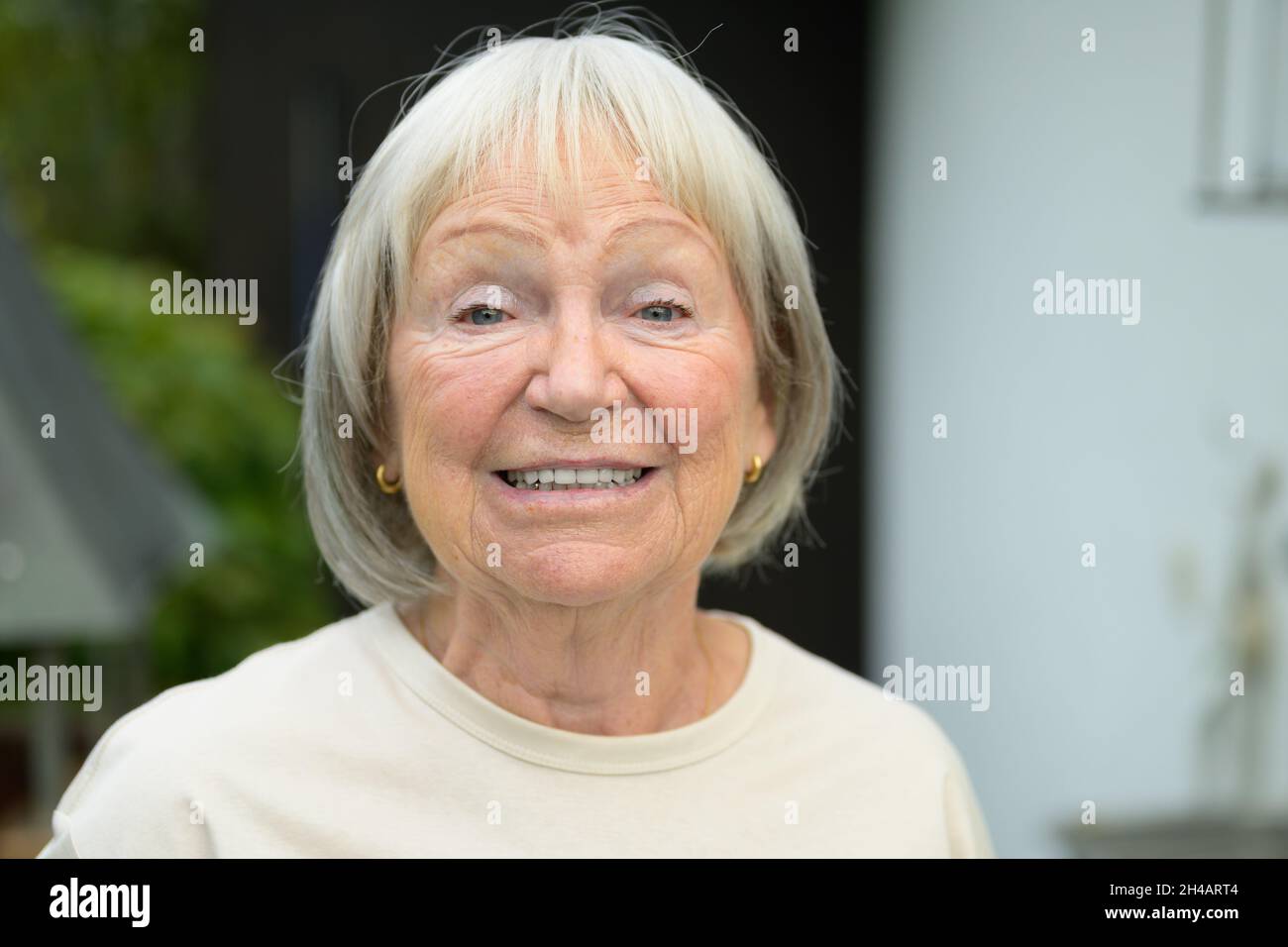 Smiling elderly Grandmother with an excited animated expression looking ...