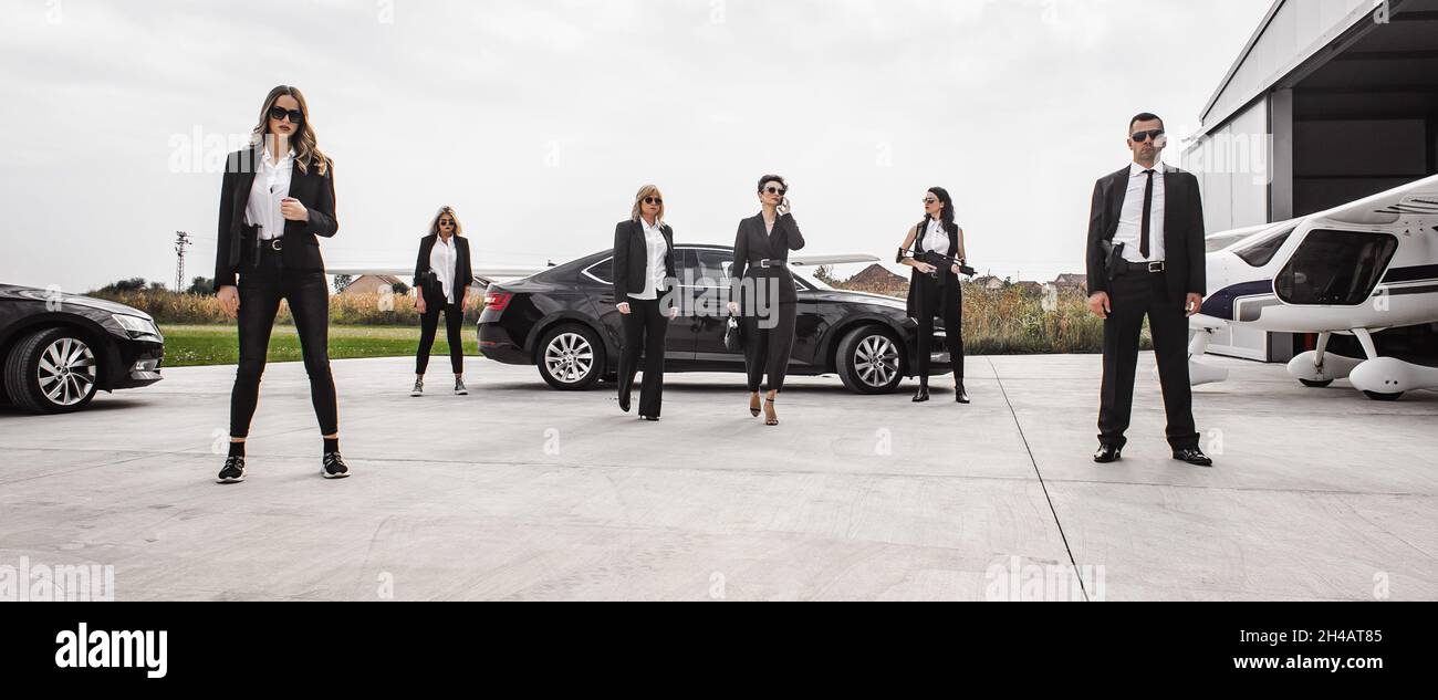 Professional team of female and male bodyguards protect famous VIP ...
