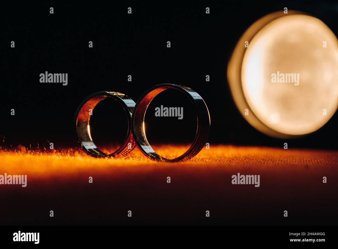 Two wedding rings on a red background. Gold rings of a couple in love ...