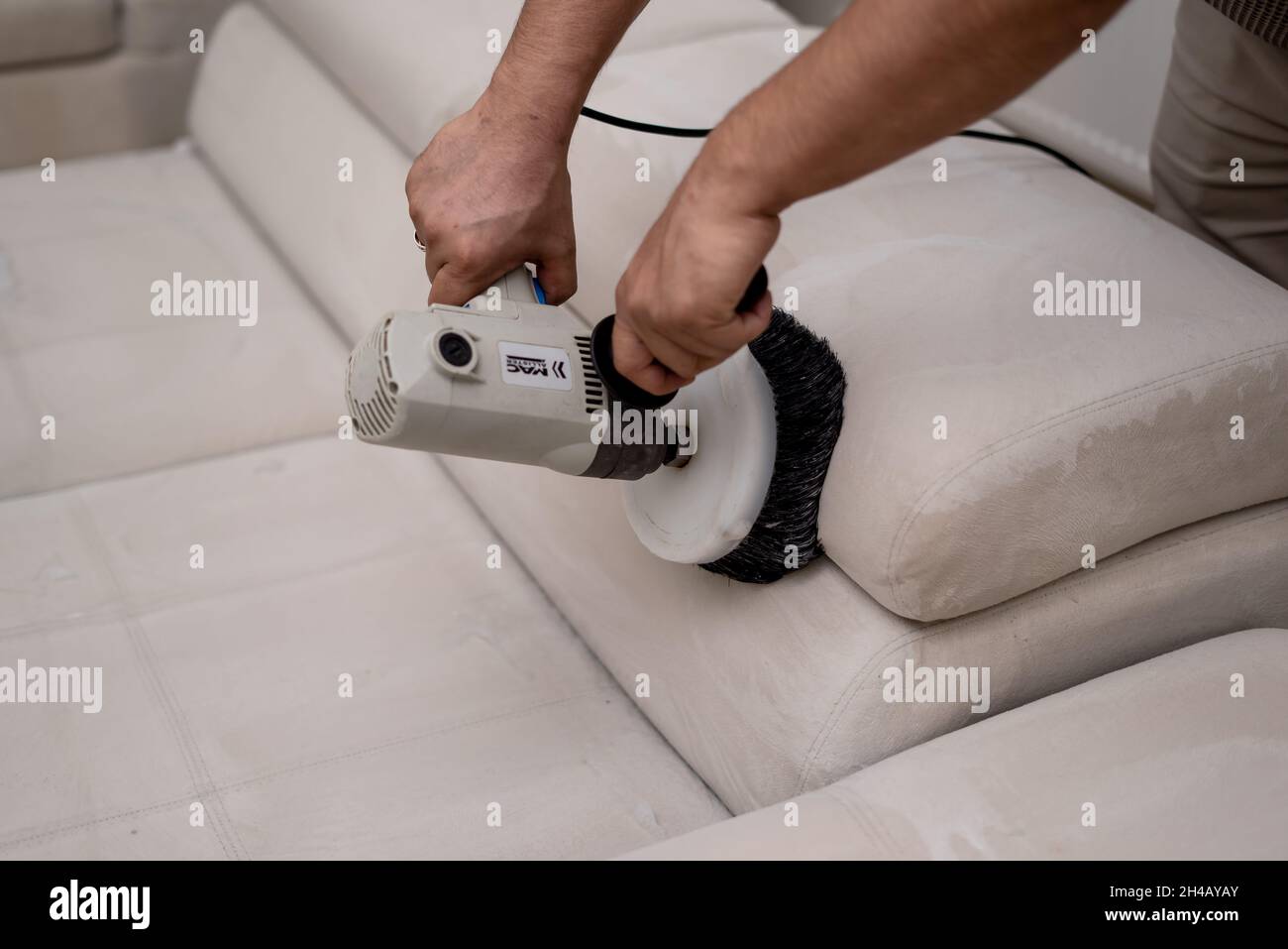 Cleaning a dirty sofa with a sofa washer Stock Photo - Alamy
