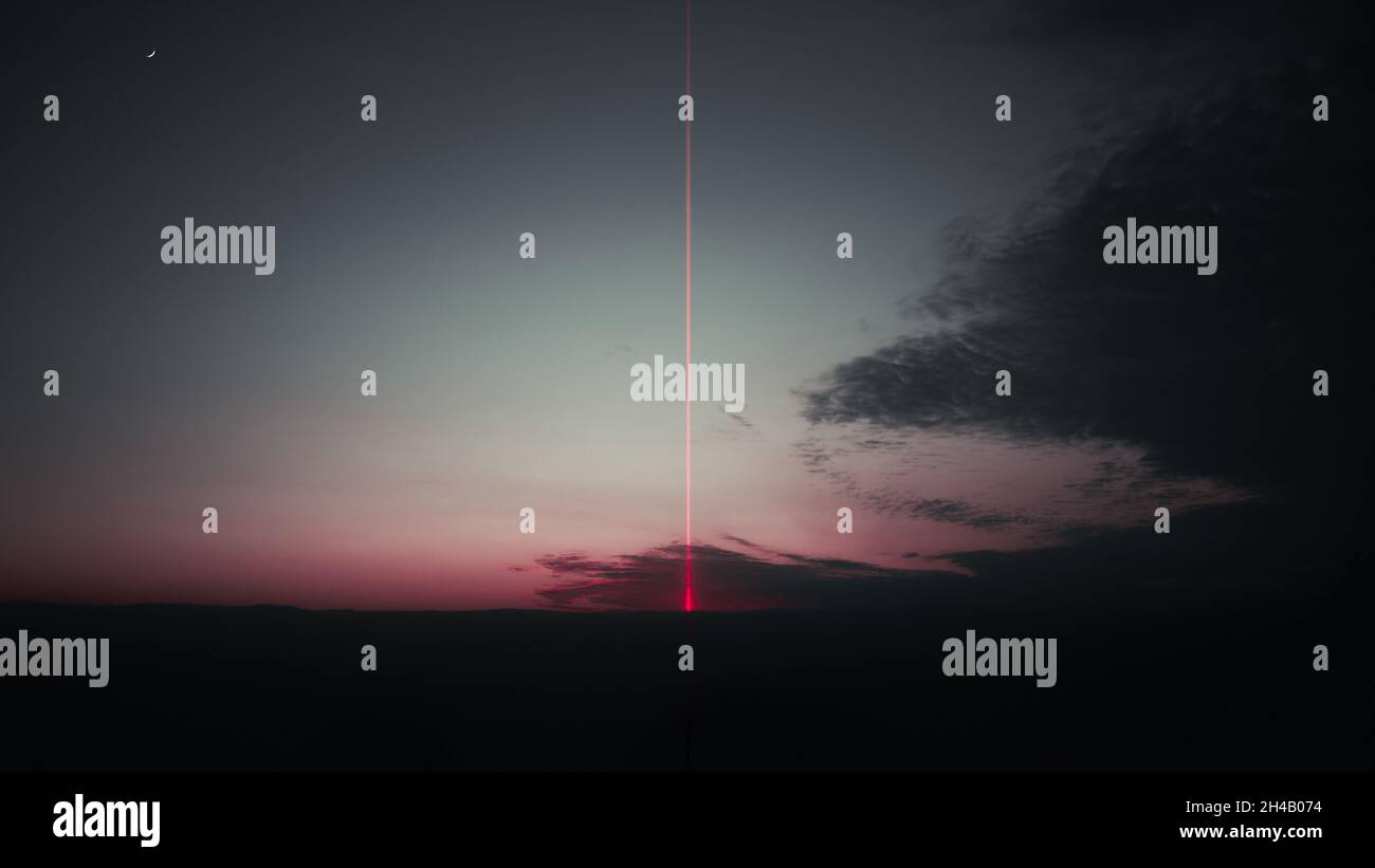 Beautiful view of the cloudy night sky with a laser light Stock Photo ...