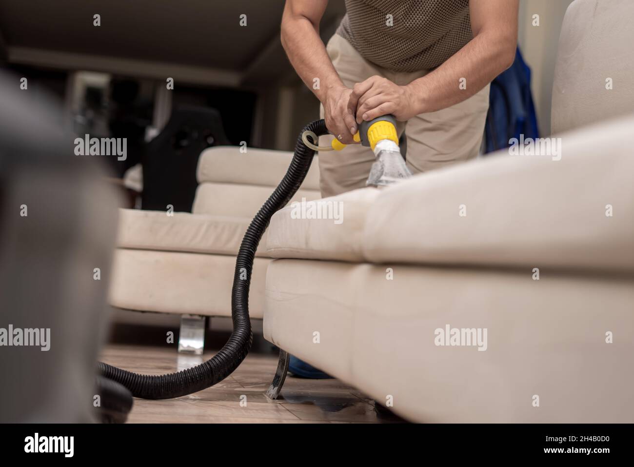 Cleaning a dirty sofa with a sofa washer Stock Photo - Alamy