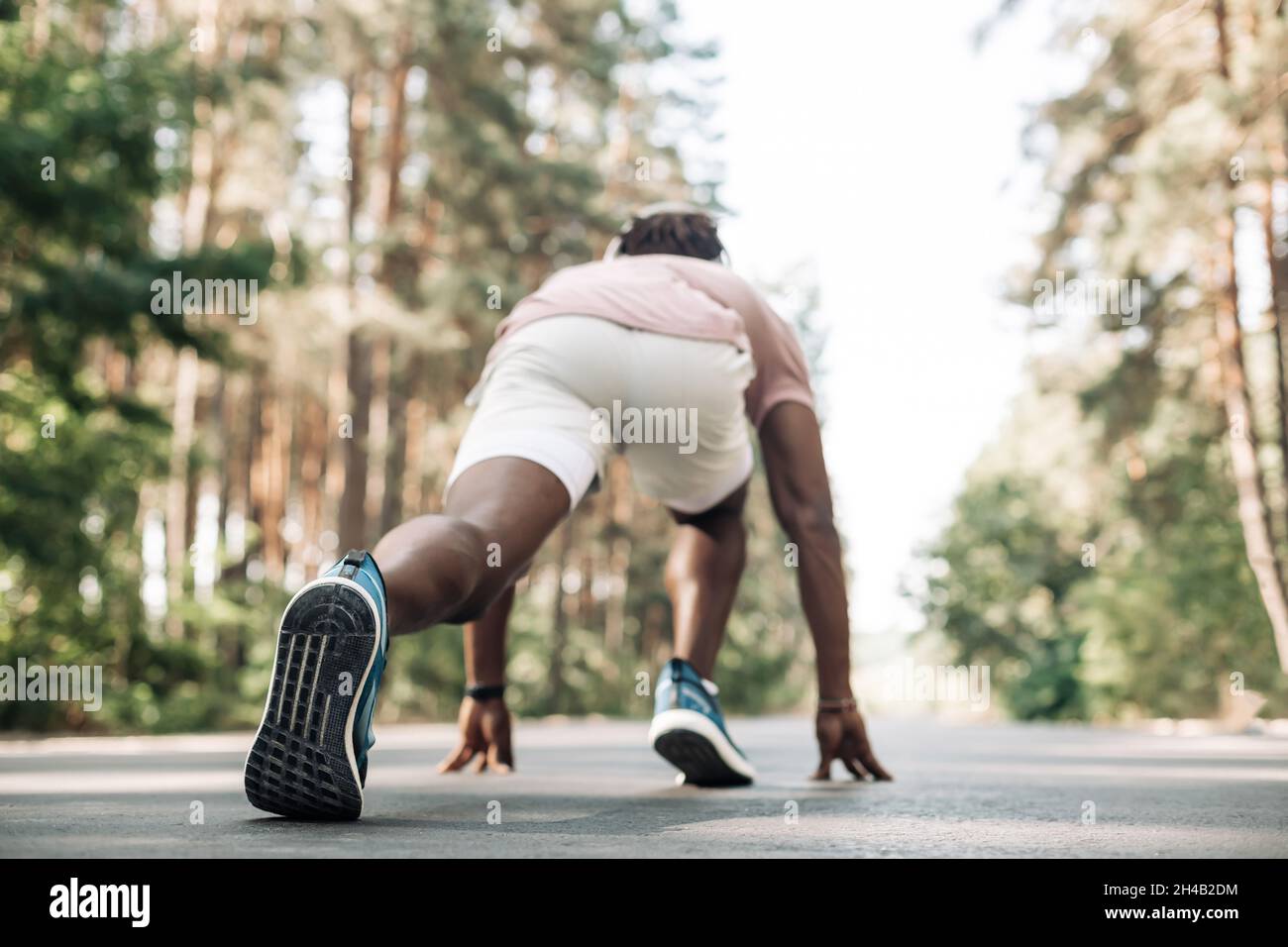 Fit black male sprinter, in starting position ready to run, Male ...