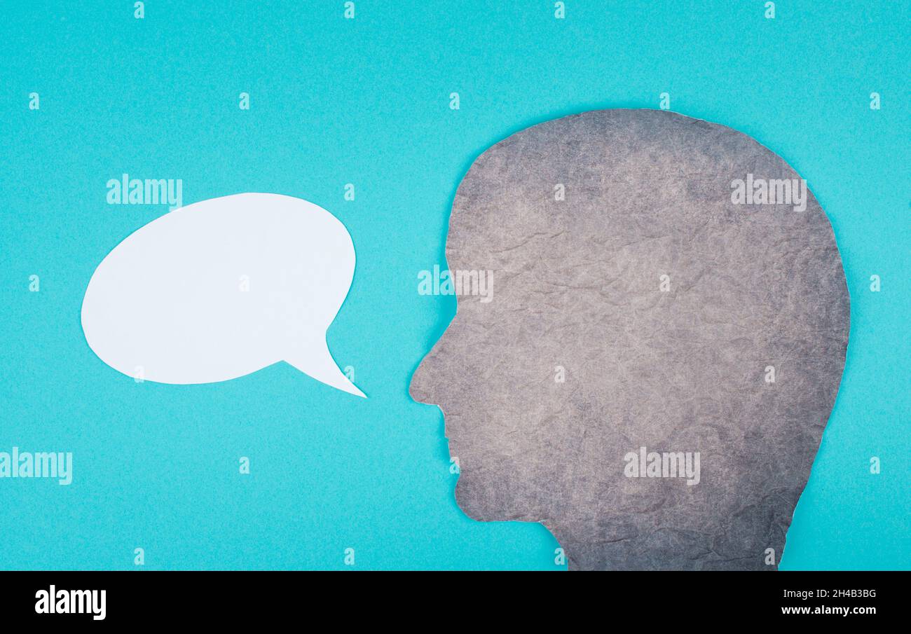 Silhouette of a face made with scrambled paper, speech bubble in white ...