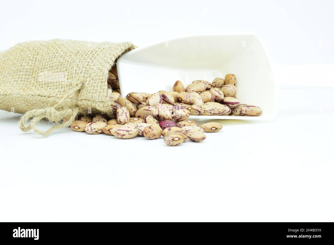 Sack of beans and a plastic scoop on the white background Stock Photo ...