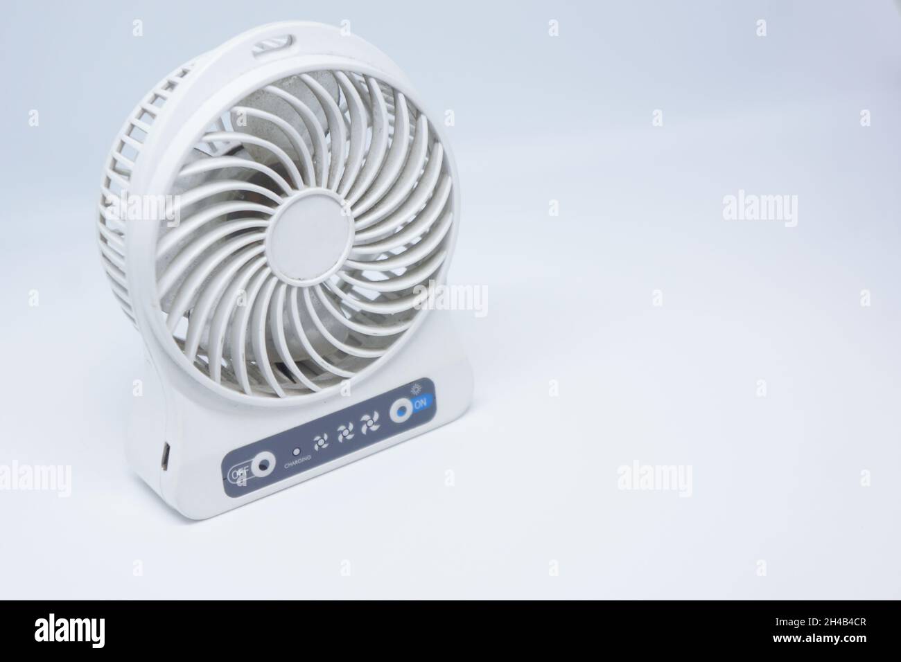 White USB and battery-operated rechargeable fan isolated on a white ...