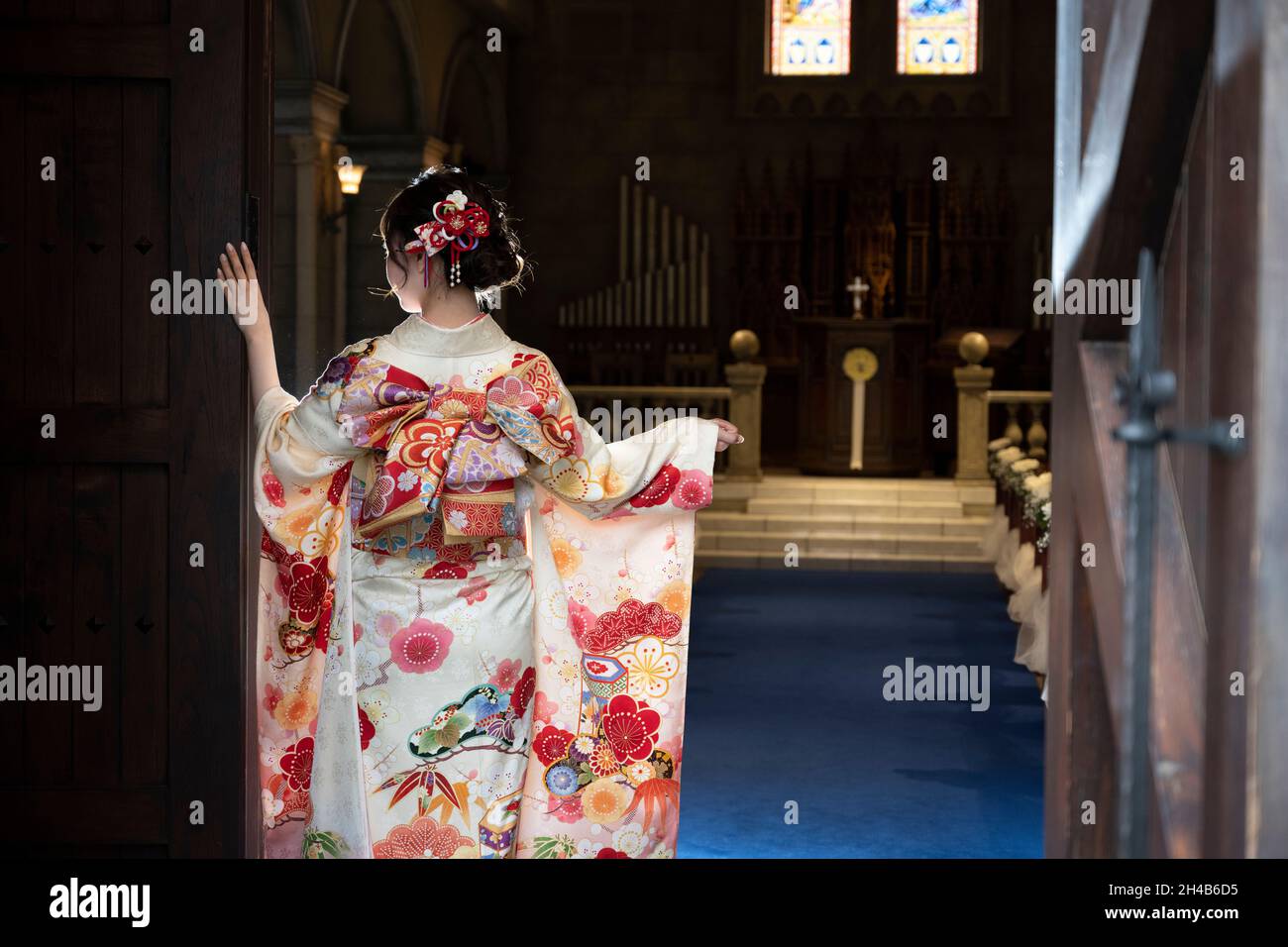 A woman spreading the furisode in a chapel Stock Photo - Alamy