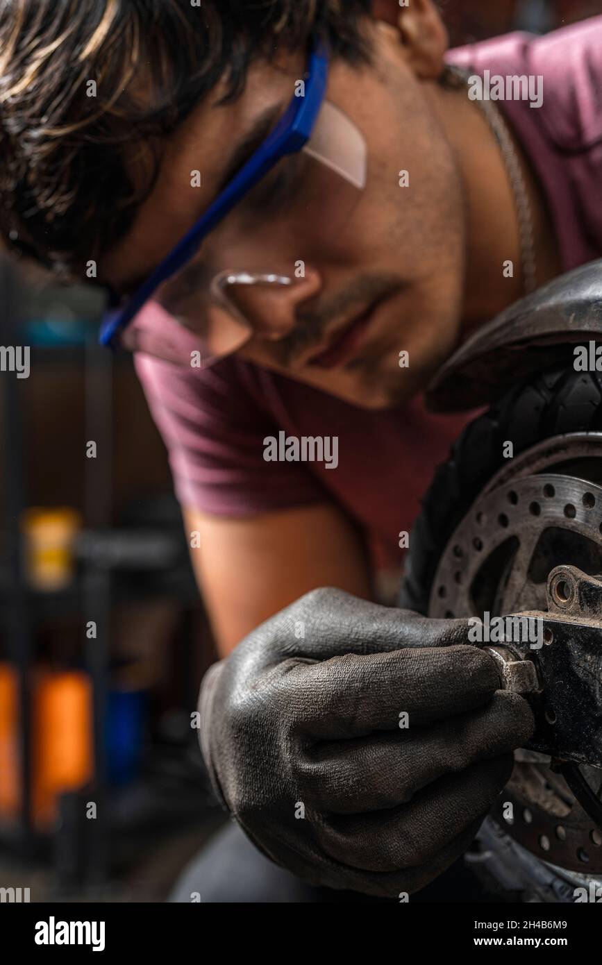 Vertical image of a mechanic with safety goggles putting in place the ...