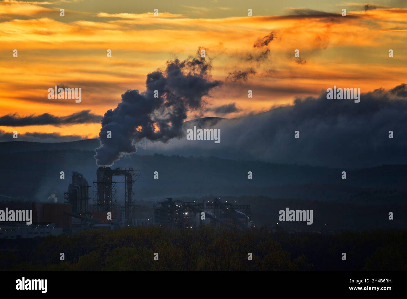 Sunrise over a village with the wood factory and its smoke Stock Photo ...