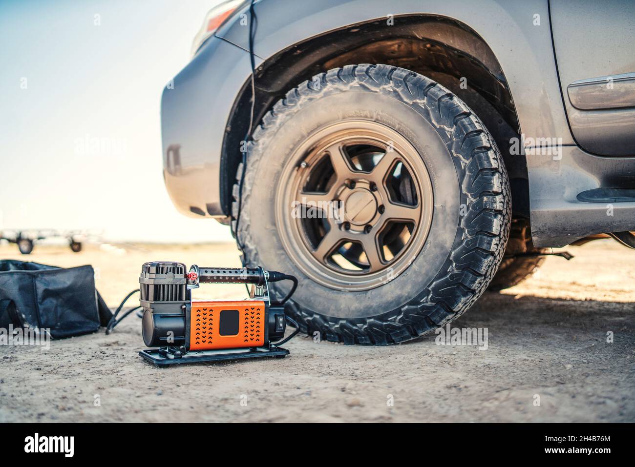 Inflating tires after four wheel trail riding Stock Photo - Alamy