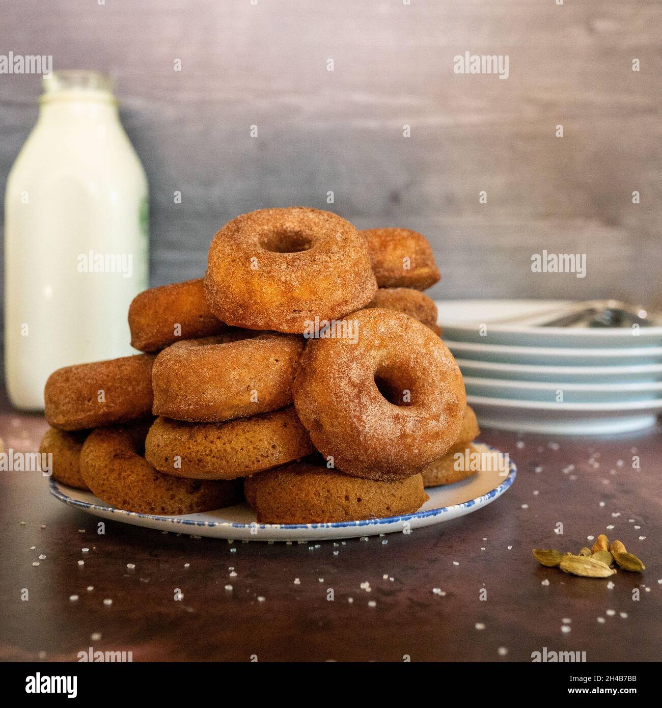 Spiced donuts with milk and plates Stock Photo - Alamy