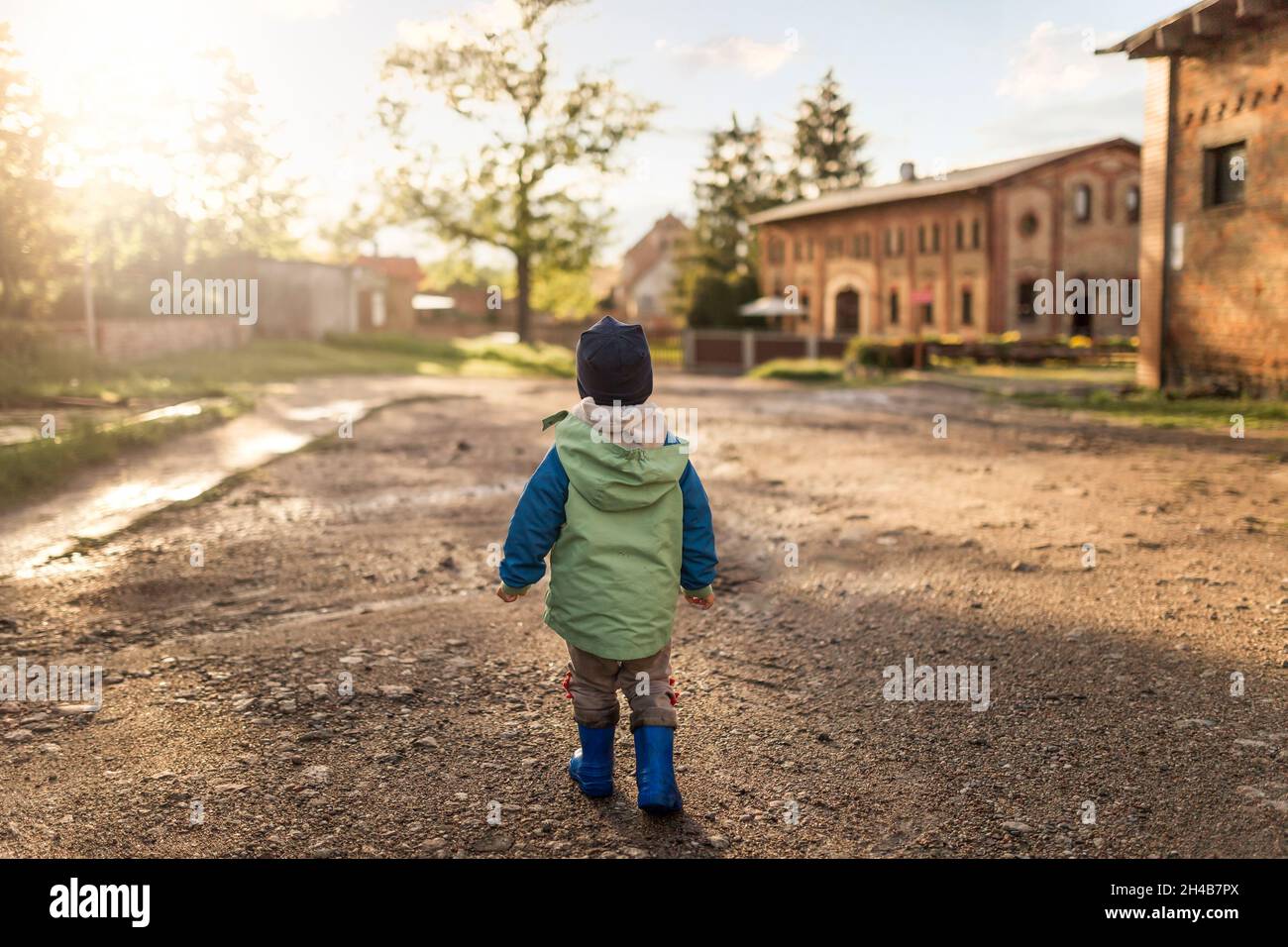 Back view of small boy walking on countryroad and looking ahead Stock ...