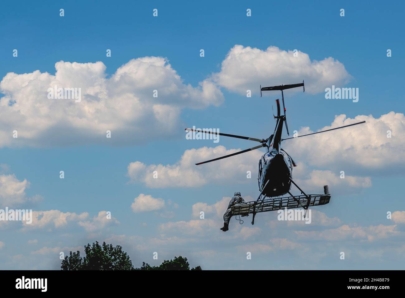 Man on Helicopter Skid Stock Photo - Alamy