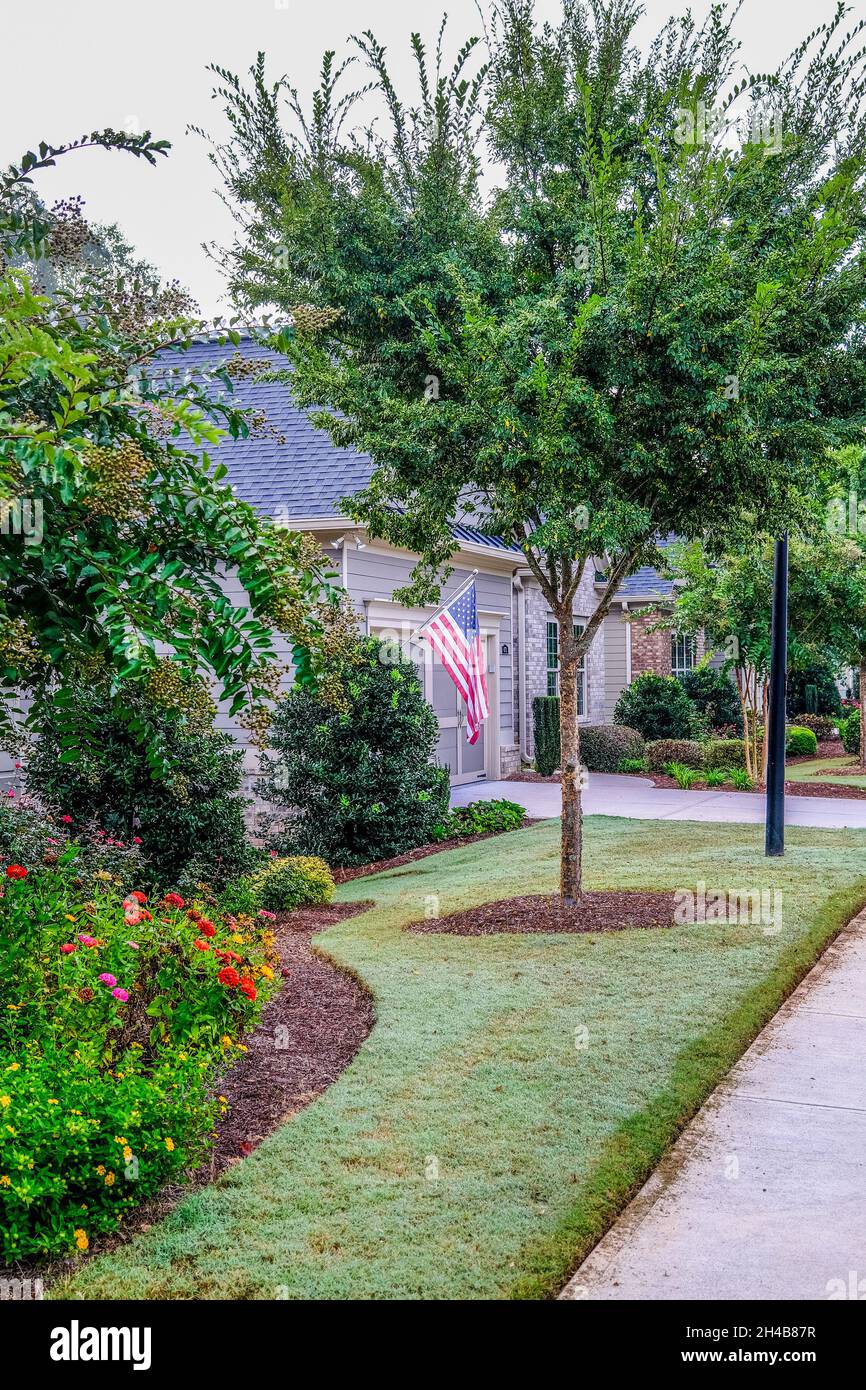 American Flag on Townhouse Beyond Trees Stock Photo - Alamy