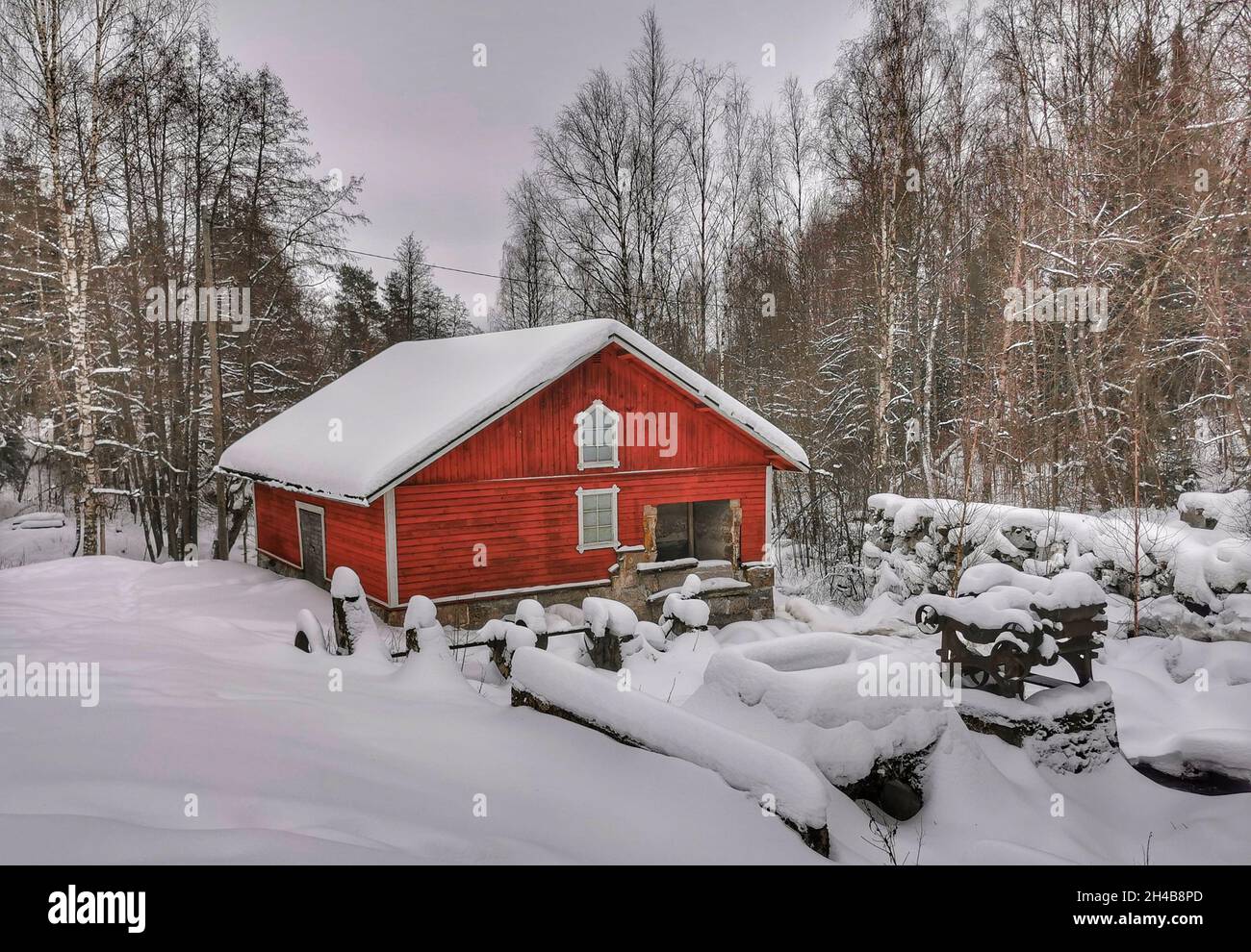 Wooden made red cabins in a forest. Snowy weather Stock Photo - Alamy