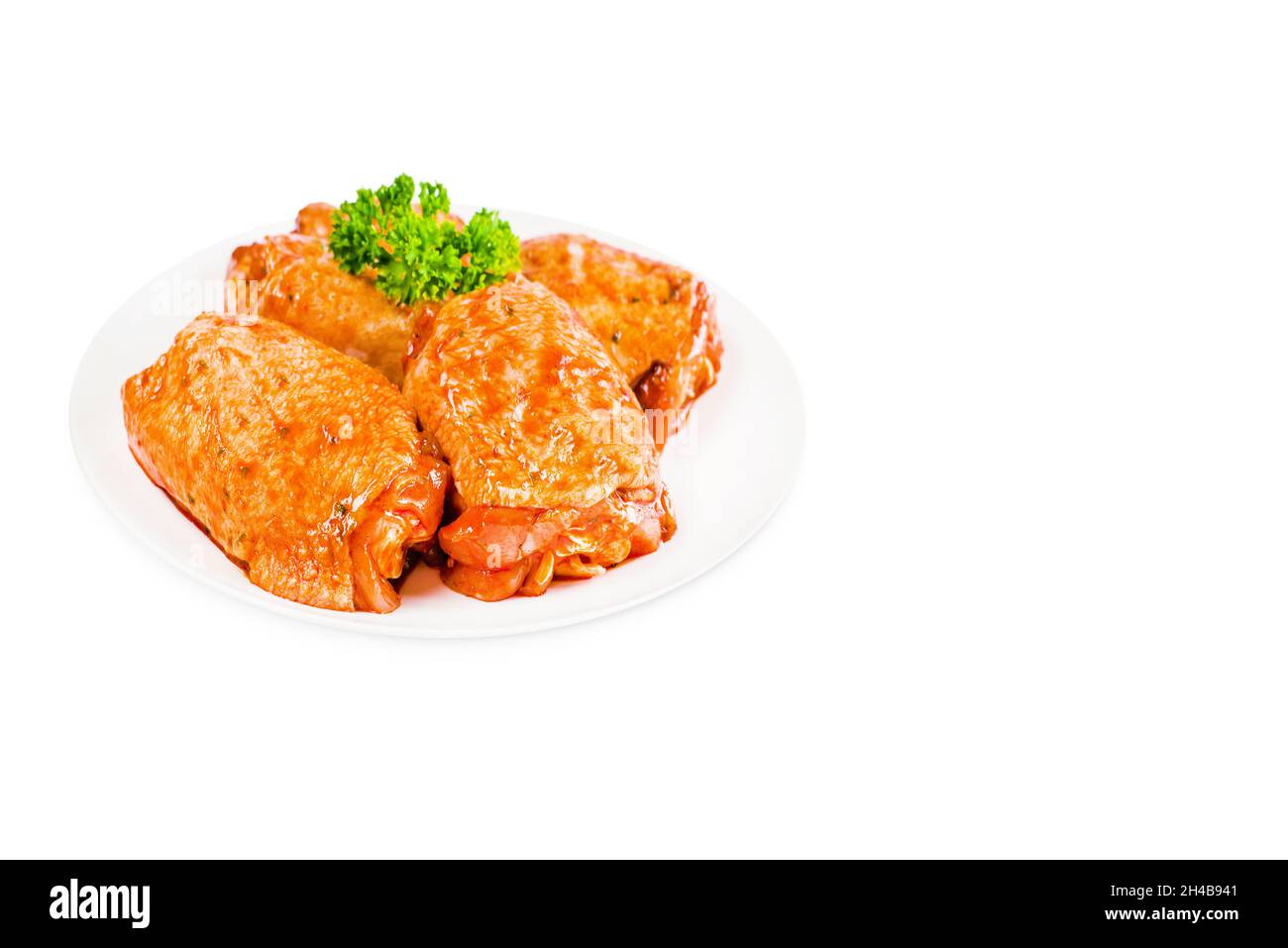 Chicken semi-cooked thighs.Raw marinated in red sauce chicken thighs on ...