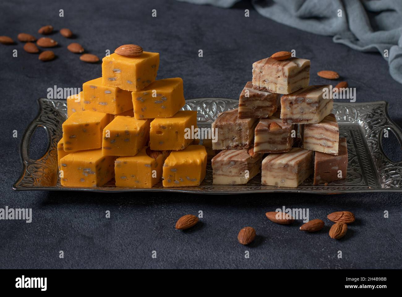 Traditional Uzbek sweet halva with almonds, cocoa, melon and sunflower ...