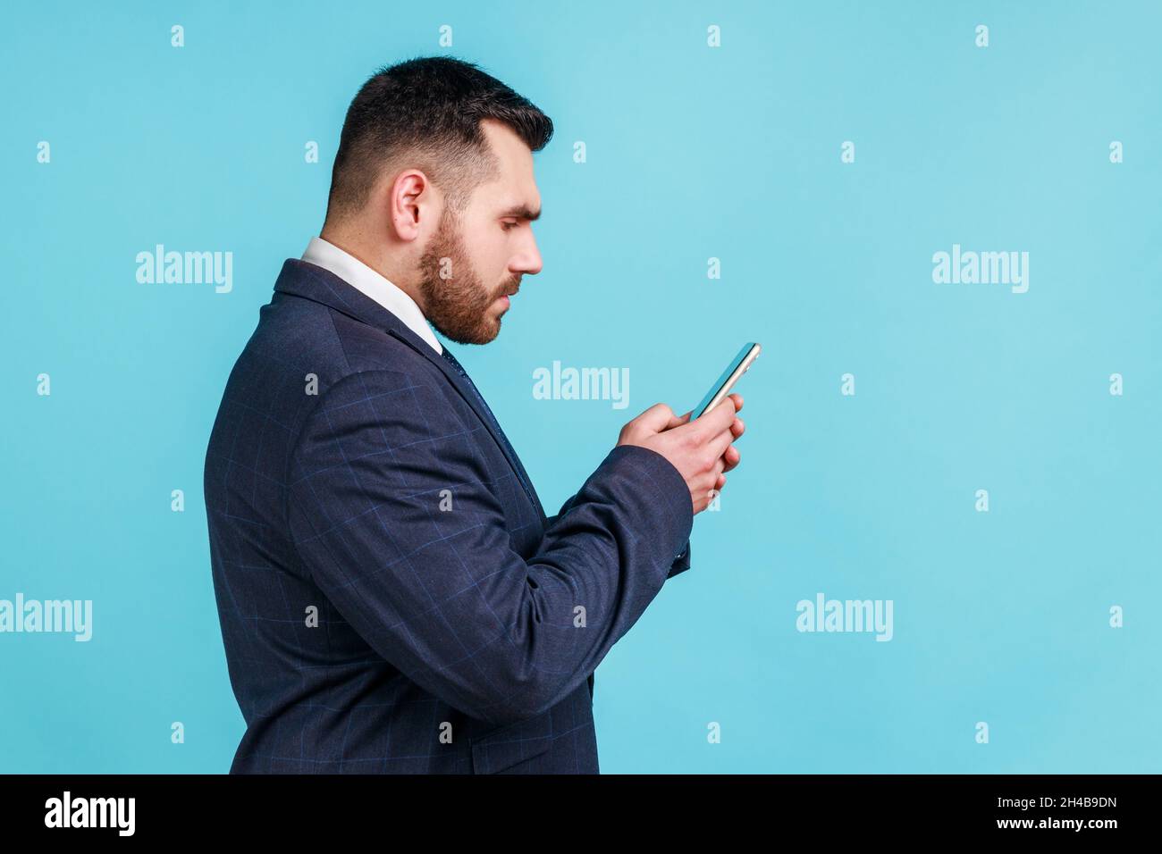 Side view serious assertive man wearing official style suit using ...