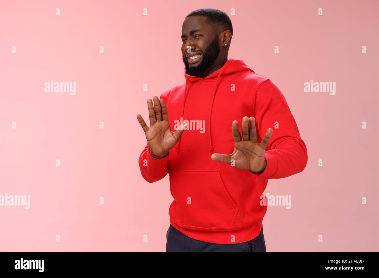 Awkward african american guy step back cringing dislike unwilling go ...