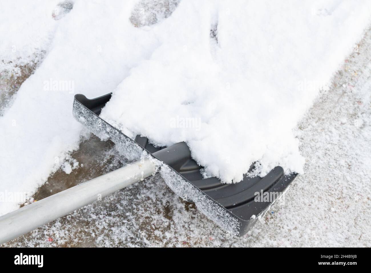 Snow cleaning with a large shovel in winter Stock Photo - Alamy