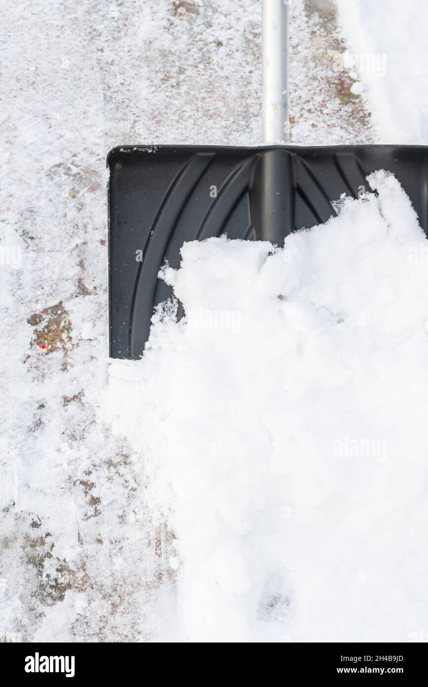 Snow cleaning with a large shovel in winter Stock Photo - Alamy