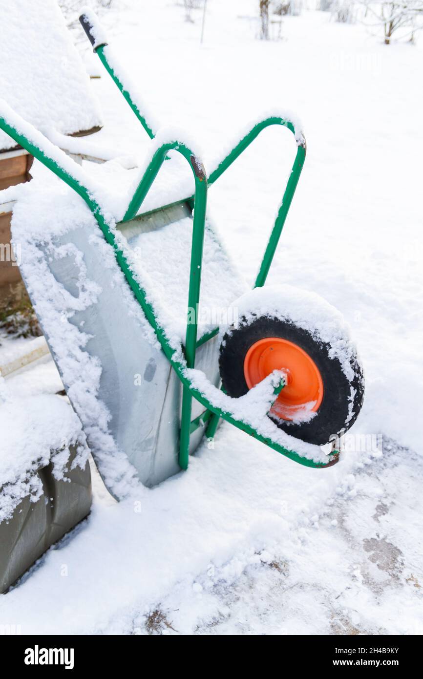 Metal garden wheelbarrow in the snow in winter Stock Photo - Alamy