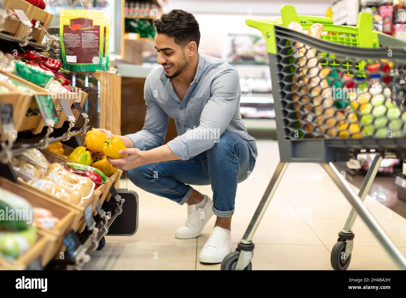 Happy Arab Guy Buying Vegetables Doing Grocery Shopping In Modern ...