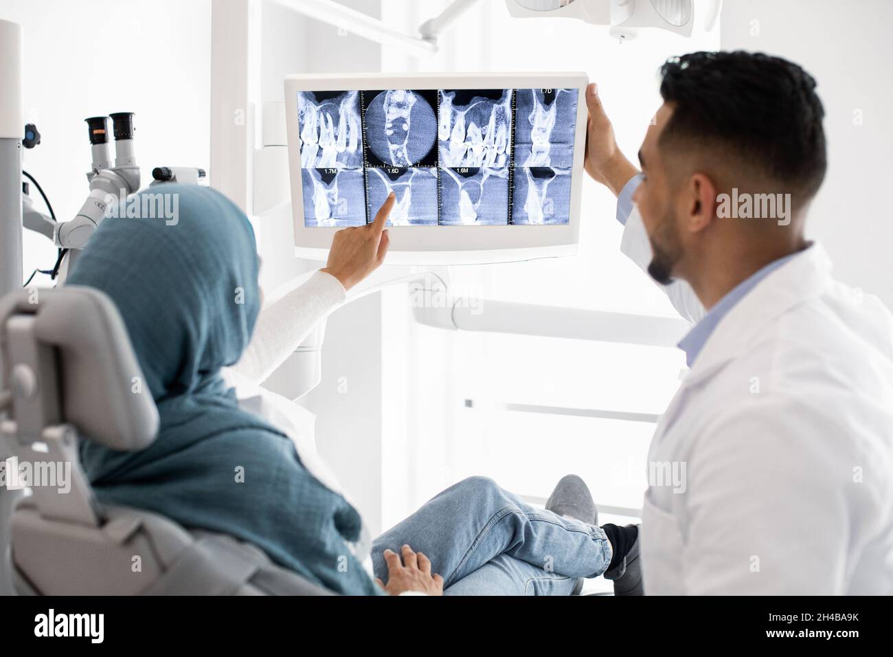 Middle Eastern Male Dentist Showing Teeth Xray Picture On Digital ...