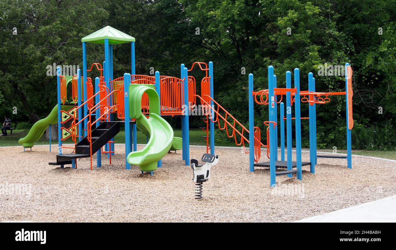 Playground with a colorful fun slide Stock Photo - Alamy