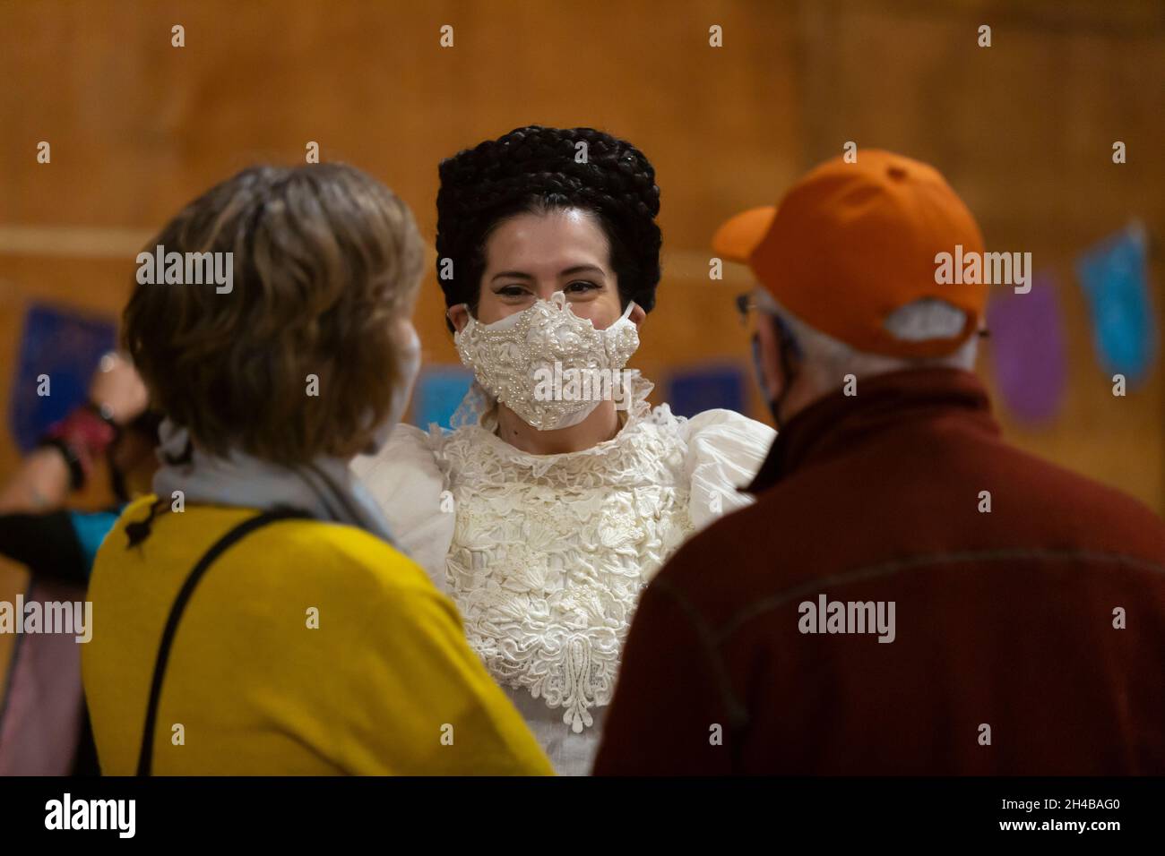 Artist Emily McLaughlin speaks with visitors at the Dia de los Muertos ...