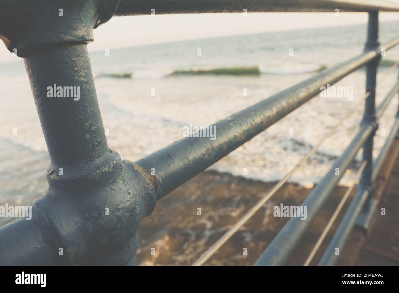 Beautiful view of the beach through the metal railings Stock Photo - Alamy