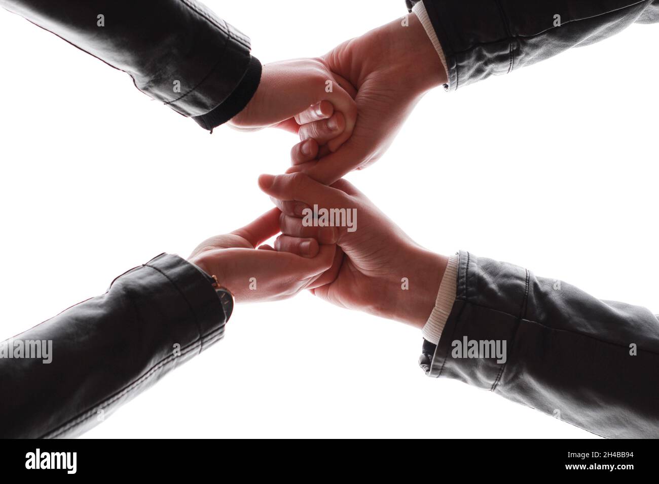 Couple's joined hands on white background Stock Photo - Alamy