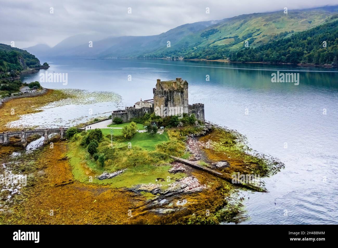 Aerial view of a beautiful Scottish castle on the shores of a sea loch ...