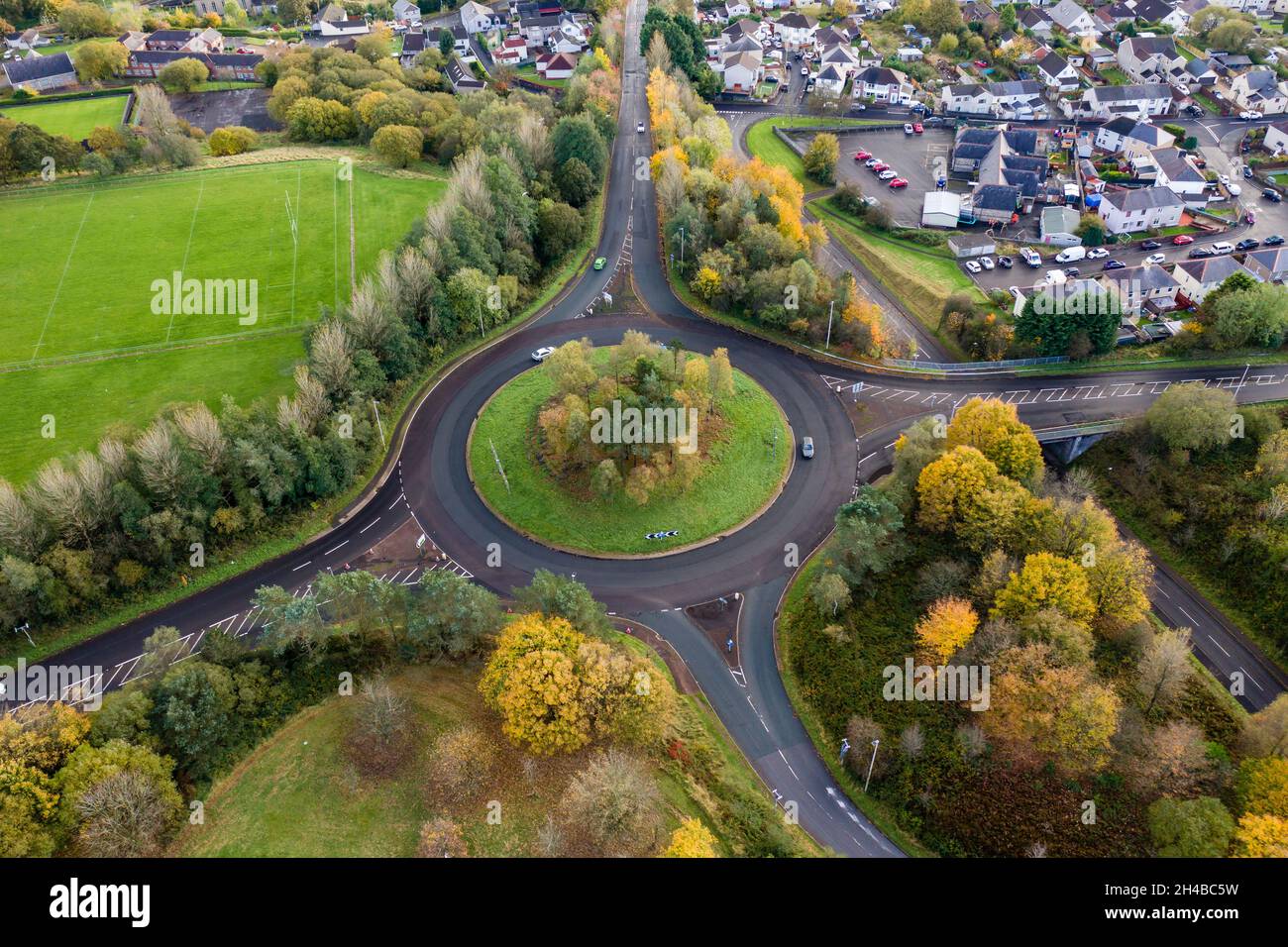 Aerial drone view of a small traffic roundabout in a Welsh town during ...